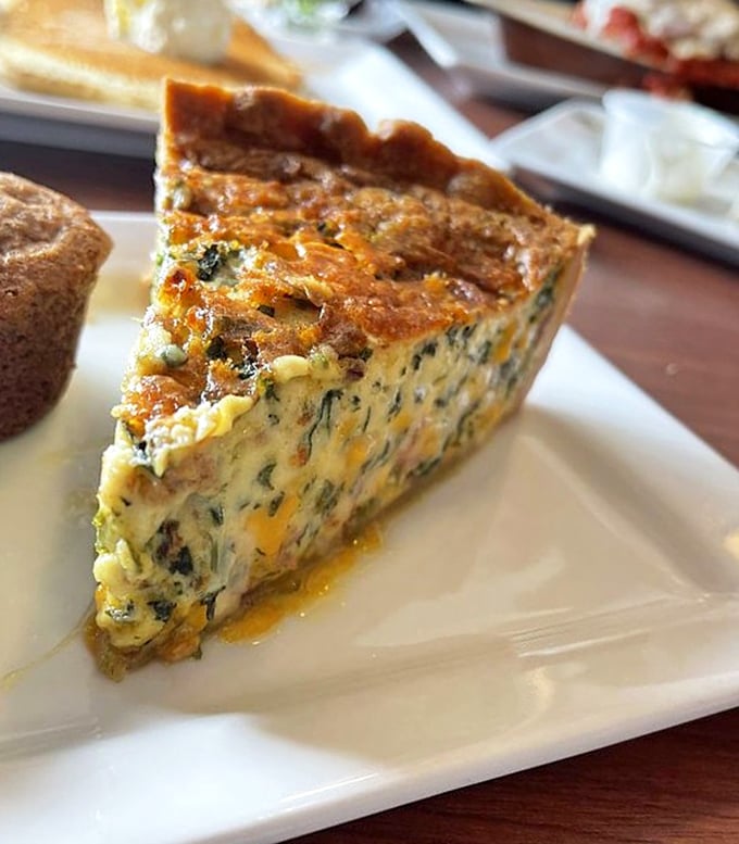 This isn't just quiche; it's an architectural marvel of eggs, spinach and bacon that makes the Empire State Building look unambitious.
