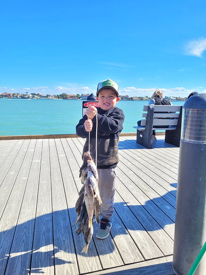 Future fishing champion in the making! Nothing beats the pride of a first catch on Pass-a-Grille's welcoming piers.