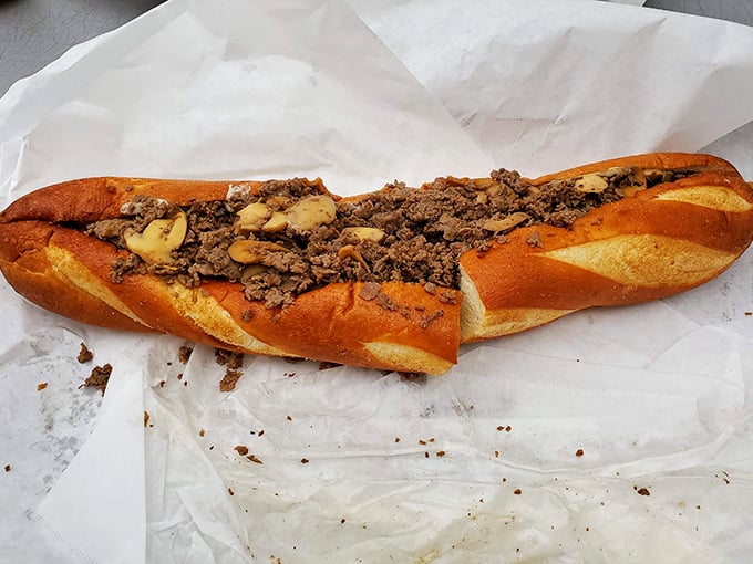 The cheesesteak in its most evolved form—tender beef mingling with mushrooms and melted cheese on a roll that somehow defies the laws of sandwich physics.
