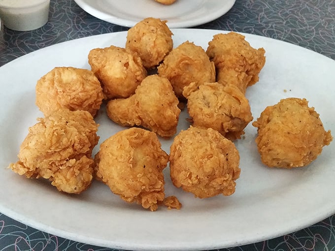 Golden fried mushrooms arrive as crispy spheres of joy, perfectly seasoned and utterly addictive.