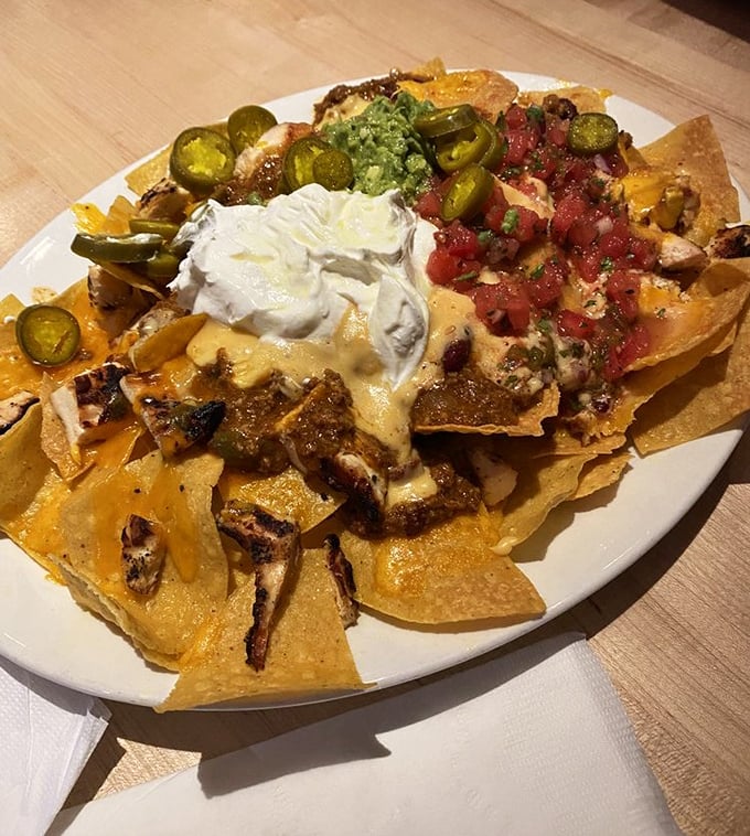 These loaded nachos aren't just a dish—they're an architectural achievement that would make Gaudí proud. A mountain of flavor with every possible topping.