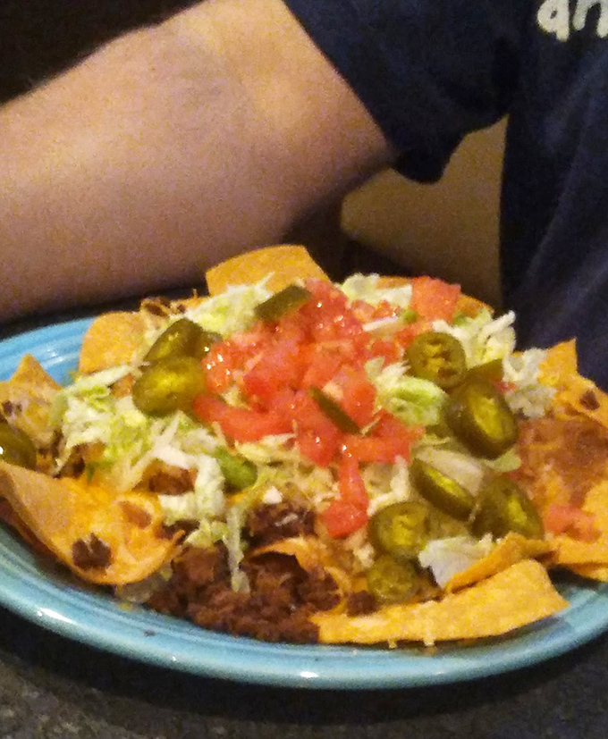 Nachos that don't mess around – loaded with jalapeños, tomatoes, and enough cheese to make Wisconsin proud. A shareable feast that rarely gets shared.