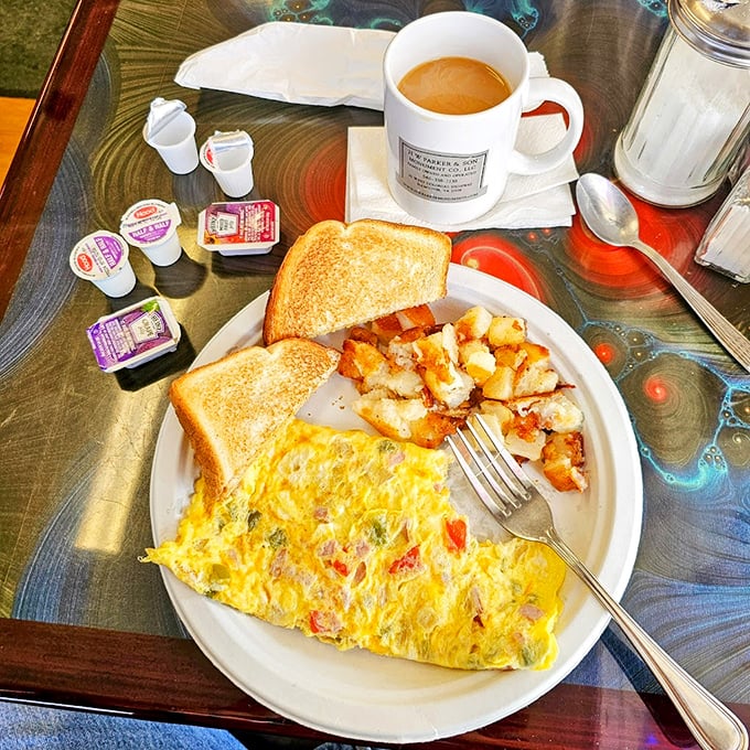 This omelet doesn't need filters or fancy plating—just eggs, veggies, and cheese coming together in perfect harmony alongside golden toast and home fries.