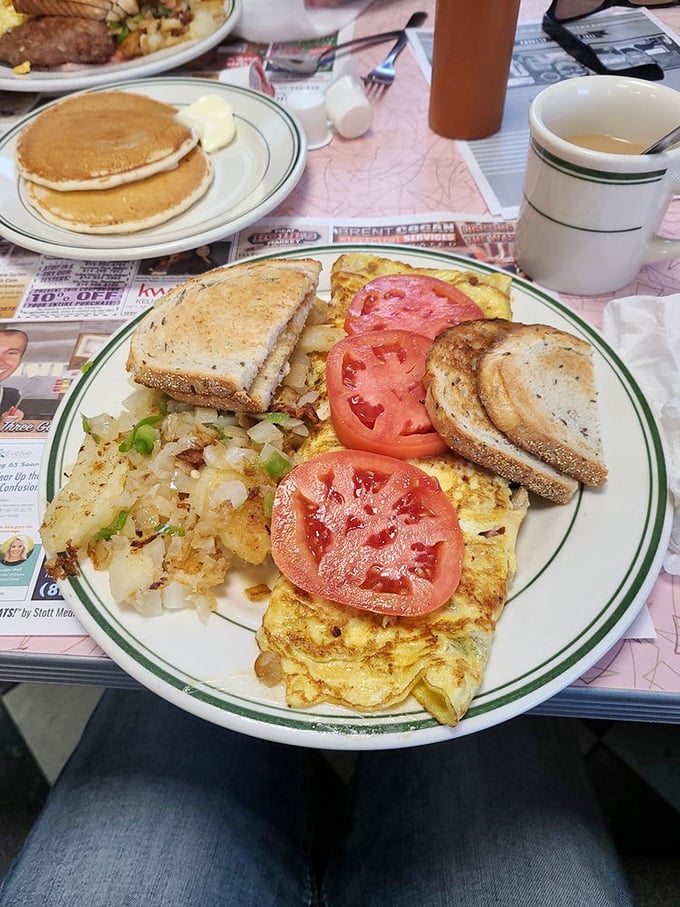 Behold the omelet that puts fancy brunch spots to shame – fluffy, generous, and absolutely picture-perfect.