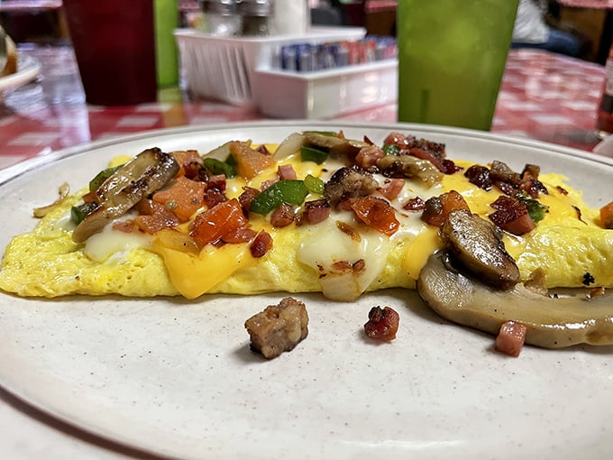 This isn't just an omelet—it's an edible mosaic of perfectly cooked eggs, melted cheese, and fresh ingredients that puts hotel breakfast buffets to shame.