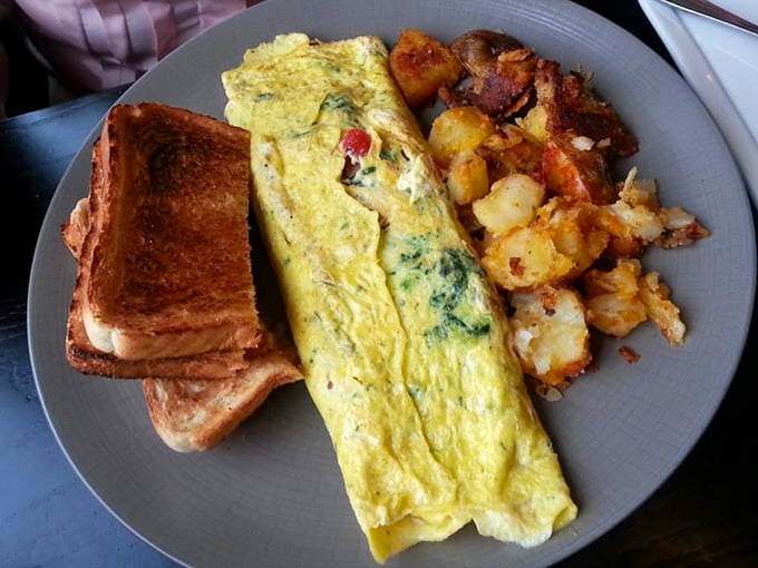 This isn't just an omelet—it's breakfast architecture. Fluffy eggs folded over fillings with the precision of an origami master.