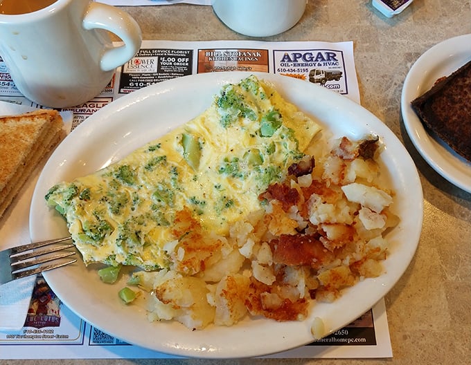 Broccoli finds its higher purpose in this fluffy omelet masterpiece. Those home fries look like they've achieved the perfect crisp-to-tender ratio that haunts my dreams.