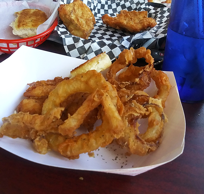 Handmade onion rings that shatter with each bite—the kind that make you wonder why anyone would ever settle for the frozen variety again.