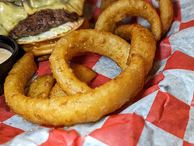 Onion rings that achieve the perfect crunch-to-tenderness ratio – the kind that make you temporarily forget your table manners.
