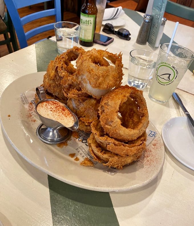 These onion rings aren't just fried – they're golden halos of crunch that make you wonder why we don't build monuments to simple pleasures.