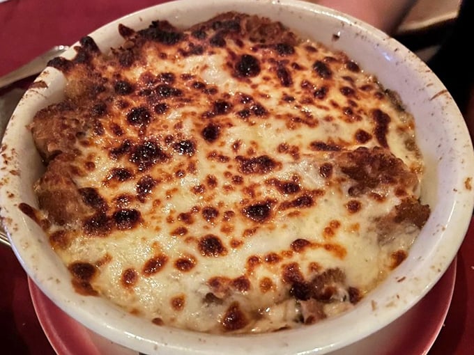 This bubbling masterpiece isn't just any French onion soup—it's a cheese-crowned comfort that would make Julia Child weep with joy.