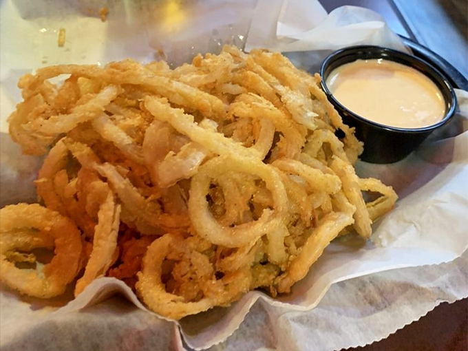 These aren't just onion straws—they're golden, crispy tangles of joy that somehow make the perfect vehicle for that creamy dipping sauce.