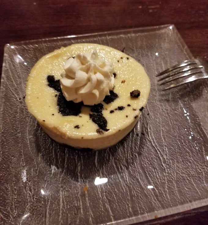 A dessert that whispers "you've earned this" after a long week. Creamy cheesecake with what appears to be chocolate crumbles—simple perfection on a glass plate.