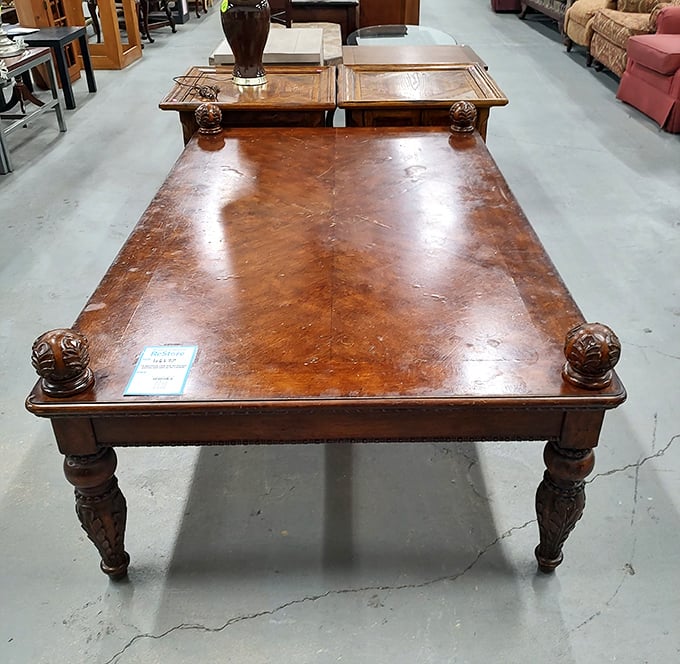 This isn't just a table—it's a conversation piece with carved legs that have probably witnessed more family arguments and holiday feasts than a therapist's notebook.