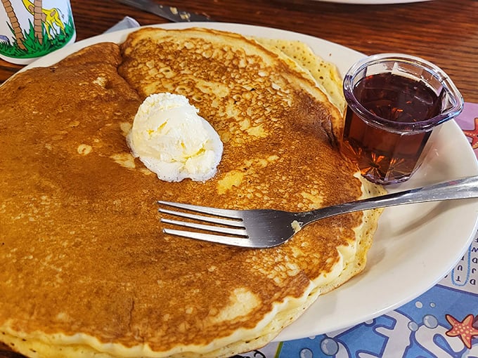 Pancakes at Marie's aren't just breakfast—they're an event. Golden-brown, plate-sized, and topped with a melting pat of butter that creates its own delicious river system.