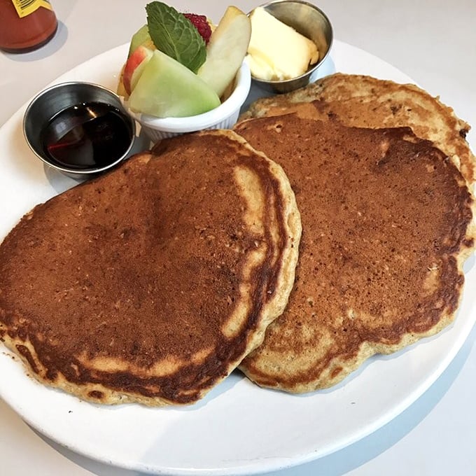 These pancakes aren't just breakfast, they're an event – golden-brown, fluffy, and served with fresh fruit that makes you feel slightly virtuous.