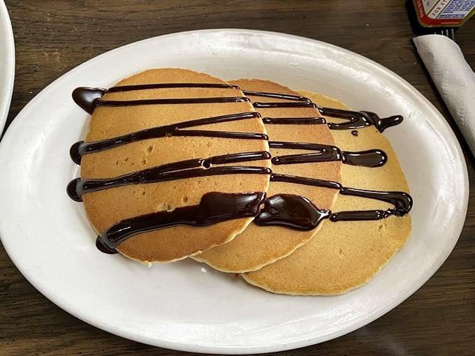 Chocolate-drizzled pancakes that make you question why anyone bothers with fancy desserts. Simple perfection that proves breakfast is the most important meal for your soul.