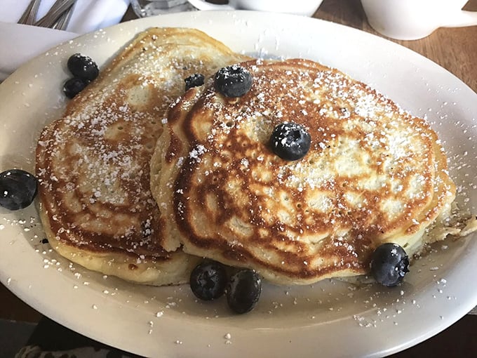 Golden pancakes dusted with powdered sugar and dotted with blueberries – proof that simplicity, when executed perfectly, needs no elaborate explanation.