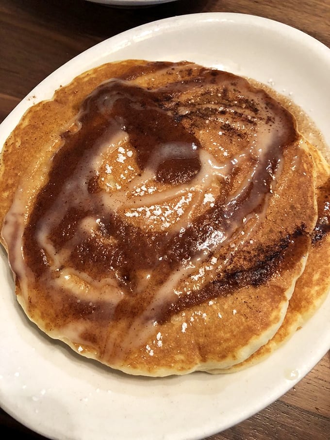 The cinnamon swirl pancake doesn't just arrive at your table – it makes an entrance, trailing its aromatic cinnamon-sugar perfume like a breakfast celebrity.