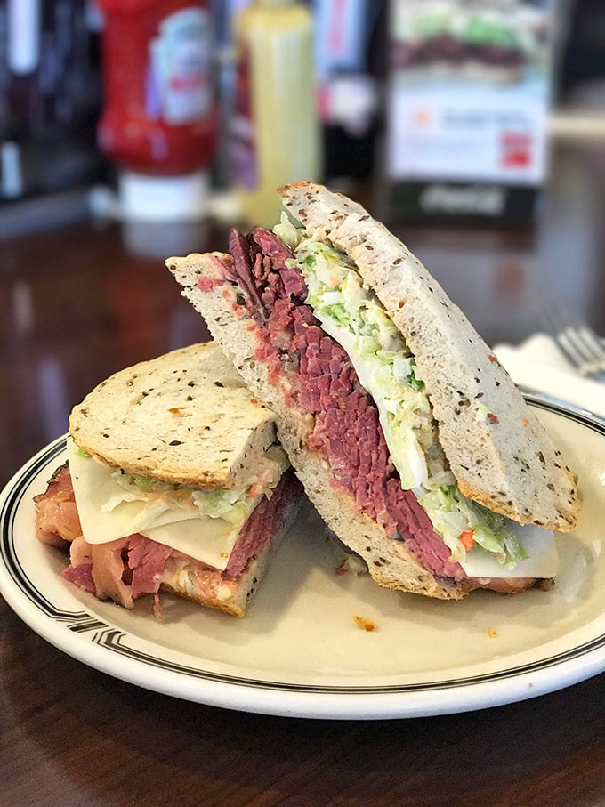 The #19 pastrami sandwich in all its glory—hand-cut meat, Swiss cheese, and coleslaw creating the holy trinity of deli perfection.
