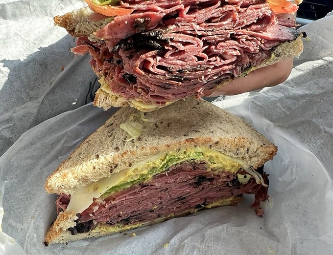 This isn't just a pastrami sandwich; it's an architectural marvel of cured meat engineering that would make Carnegie Deli nod in respect.