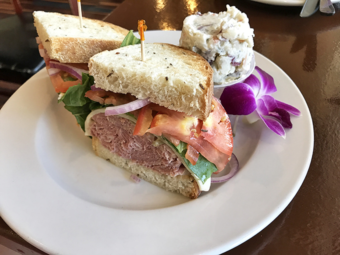 A proper deli sandwich should require both hands and several napkins—this pastrami masterpiece delivers on both counts.