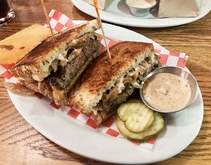 The patty melt arrives like a work of art—crispy rye bread, melted cheese, and beef in perfect harmony, with pickles standing by for moral support.