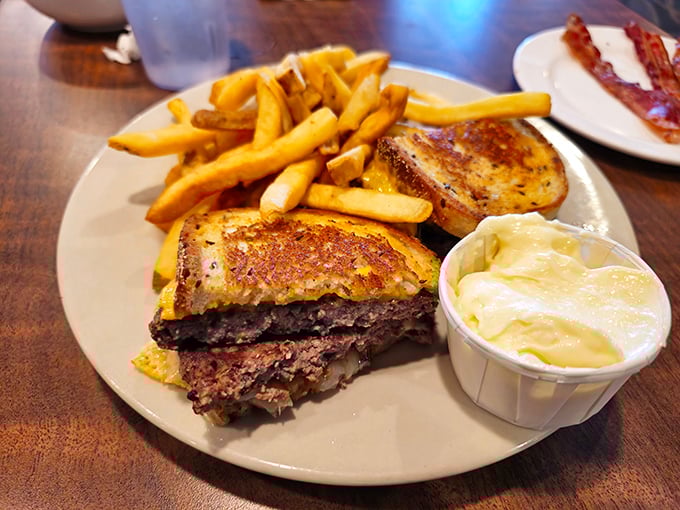 The patty melt—that perfect marriage of beef, melted cheese, and grilled bread—served with fries that somehow stay crispy until the last bite.