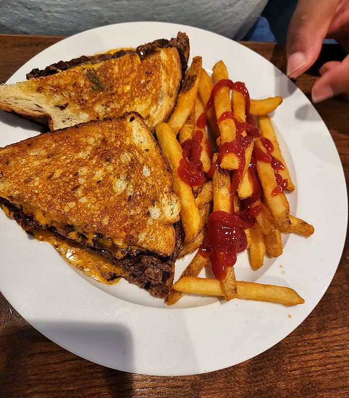 A patty melt that would make your cardiologist wince and your taste buds sing—perfectly grilled bread hugging melted cheese and beef like old friends.