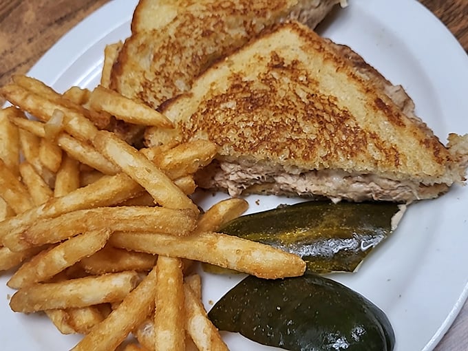 This golden-grilled patty melt isn't just a sandwich—it's a masterclass in the art of comfort food, complete with the mandatory pickle garnish.