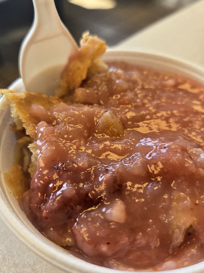 Sweet surrender in a plastic bowl—this cobbler's warm, cinnamon-kissed filling and golden crust might just make you forget your table manners entirely.