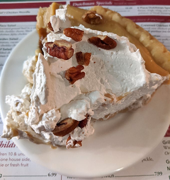 Pecan cream pie that makes you question every dessert decision you've ever made. Those nuts aren't just toppings—they're little crunchy crowns of glory.