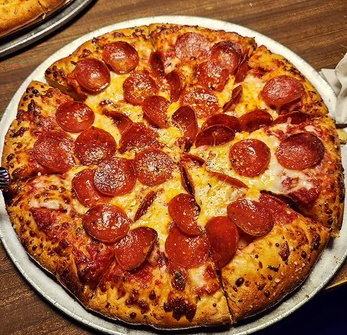 A perfect pepperoni pizza that doesn't need fancy words to describe it – just look at that cheese pull and those perfectly crisped edges.