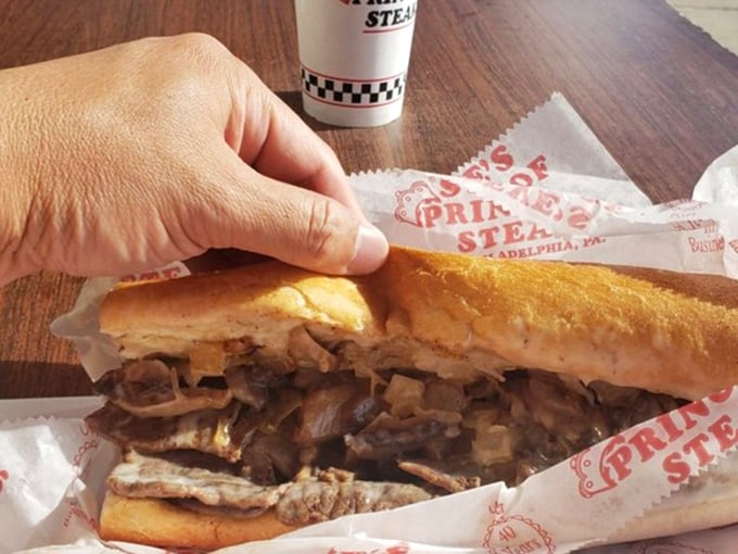 Not just a sandwich but an engineering marvel—layers of meat and cheese creating the architectural wonder that is a proper Philly cheesesteak.