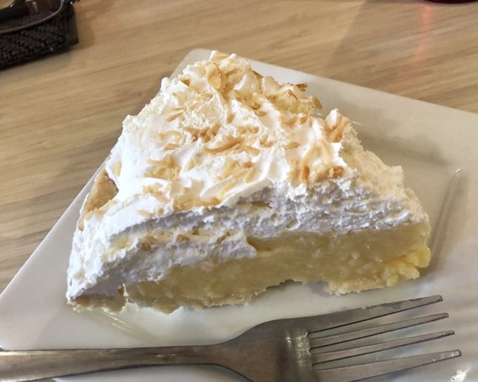 This isn't just pie—it's a towering monument to the art of dessert-making, where clouds of whipped cream meet velvety filling in perfect harmony.