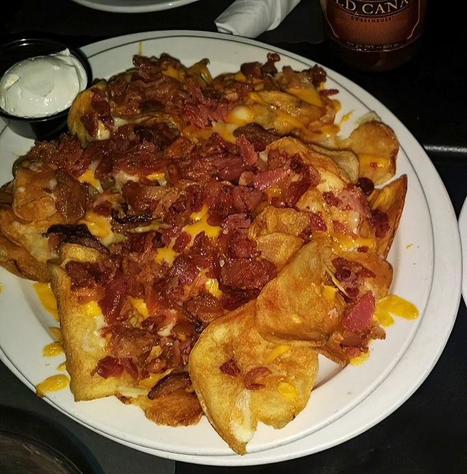 Pig Chips – where potato chips ascend to their highest calling, loaded with cheese, bacon, and absolutely zero regrets.