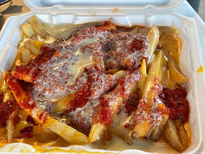 Cheese fries that could make a cardiologist weep—golden, crispy potatoes swimming in a lava flow of molten cheese and sauce.