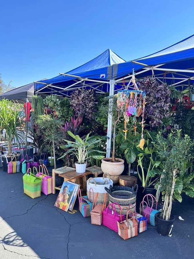 The plant vendor's oasis offers a splash of green amid asphalt. Those colorful woven bags practically beg to carry home your new leafy roommates.