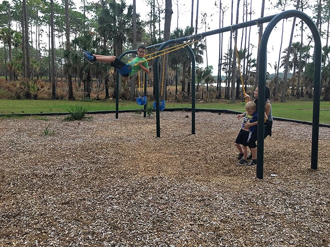 Playground physics in action: childhood joy measured in swing heights and the universal "look at me" moment every parent knows.