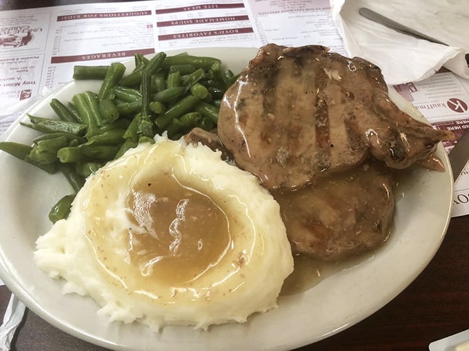 These pork chops aren't just cooked, they're loved into existence. The gravy pool isn't just a sauce—it's a destination worth visiting.