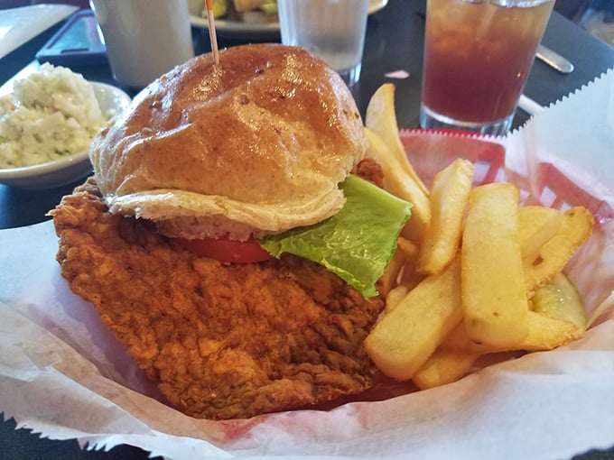 This isn't just a sandwich; it's Indiana's iconic pork tenderloin in its natural habitat—gloriously oversized and perfectly crisp.