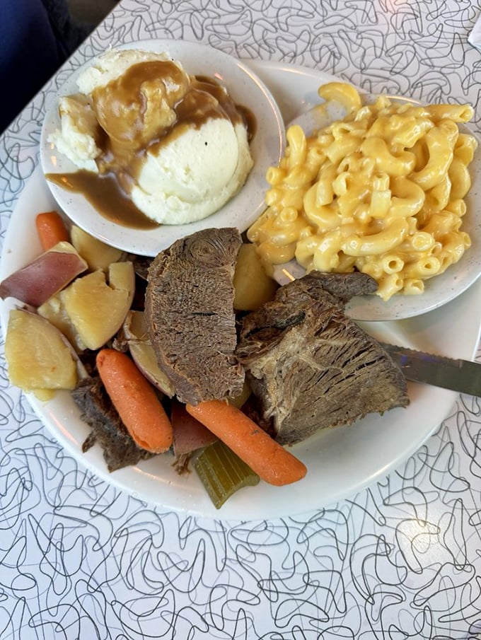 This pot roast plate doesn't just feed the stomach; it nourishes the soul with tender beef, vegetables, and mac & cheese that means business.