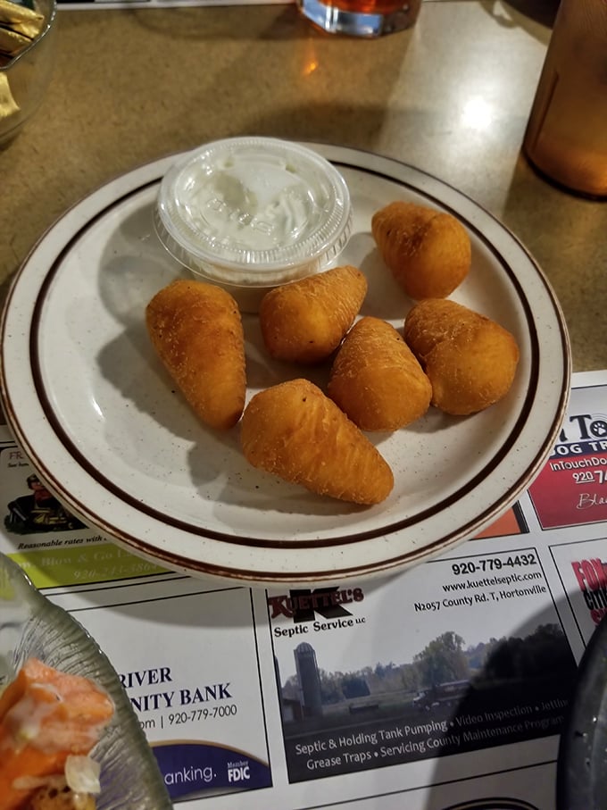 Golden-brown potato puffs that crunch like your childhood dreams, served with a side of nostalgia and enough dipping sauce to make you forget your manners.