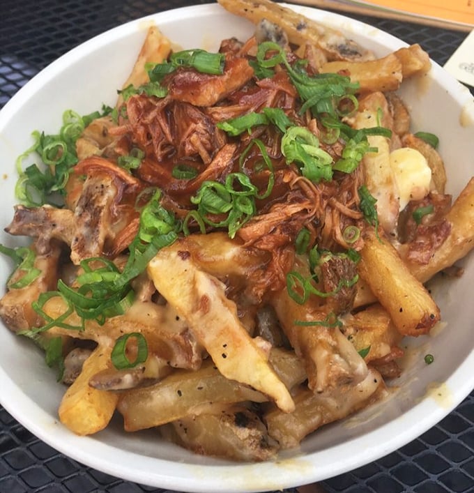 Poutine: Canada's greatest contribution to humanity besides politeness. Crispy fries swimming in gravy with cheese curds and pulled pork—comfort in a bowl.