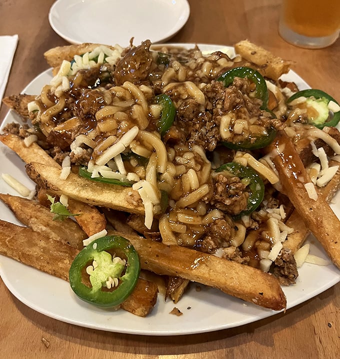 Loaded fries that would make a Canadian blush—crispy potatoes buried under savory meat, melted cheese, and jalapeños for those brave enough to embrace the heat.