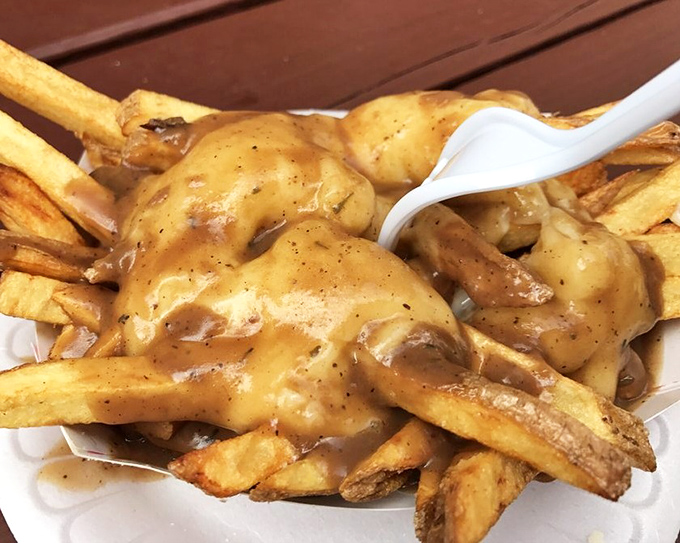 Gravy's love letter to french fries. These poutine fries aren't just a meal—they're comfort in edible form, a warm hug on a plate.