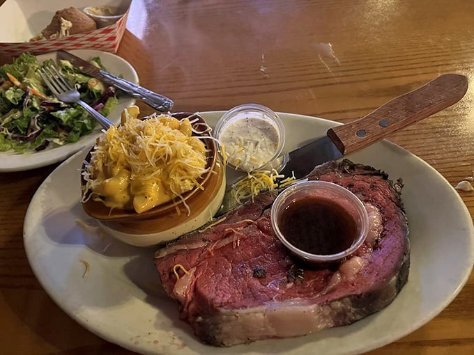 This prime rib isn't just dinner—it's a carnivore's dream come true, perfectly pink and served with a side of cheesy goodness.