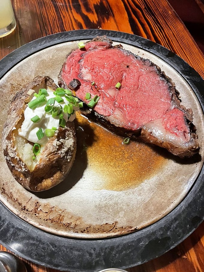 Prime rib so perfectly pink it could make a vegetarian question their life choices, paired with a potato awaiting its butter destiny.