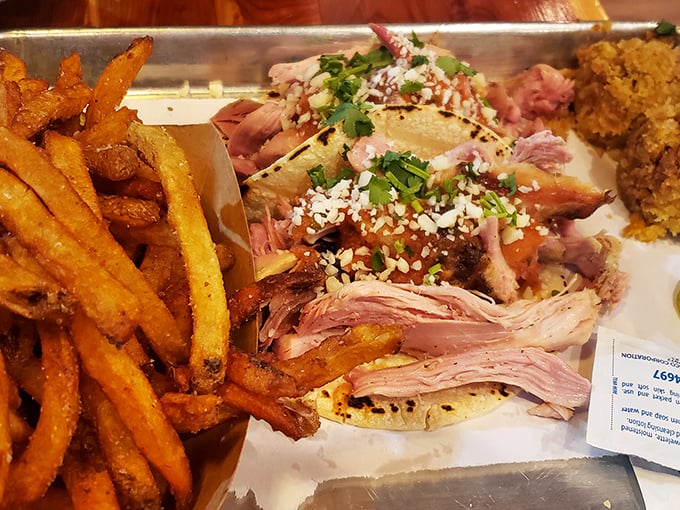 Pulled chicken tacos garnished with fresh herbs and crumbled cheese—proof that barbecue brilliance extends beyond the traditional sandwich format.
