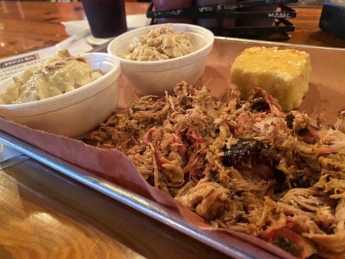 Pulled pork perfection on display with creamy sides and cornbread. This isn't just dinner – it's edible therapy after a long Michigan winter.